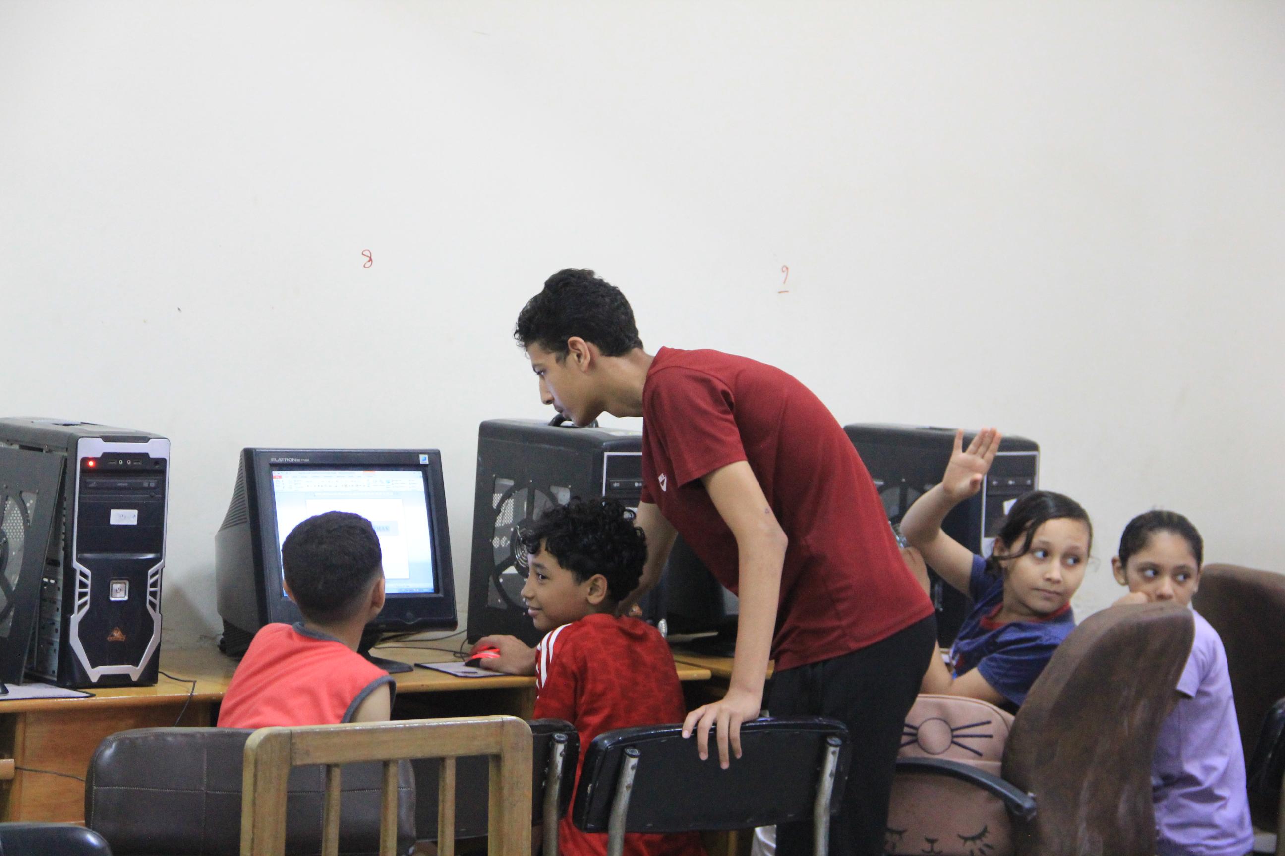 Volunteer helping students in computer lab